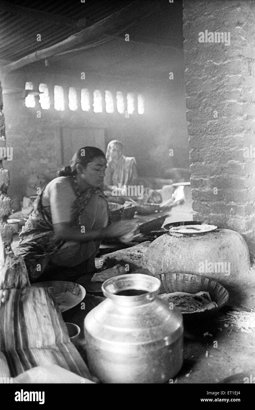 Indian woman cooking food Black and White Stock Photos & Images - Alamy