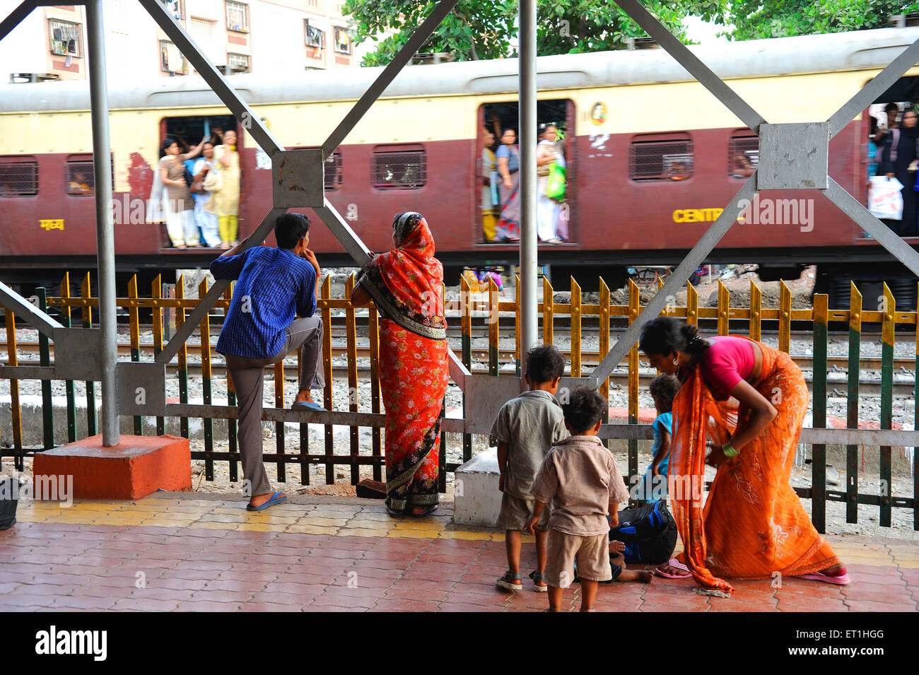 People at station watching train passing ; Bombay Mumbai ; Maharashtra ...