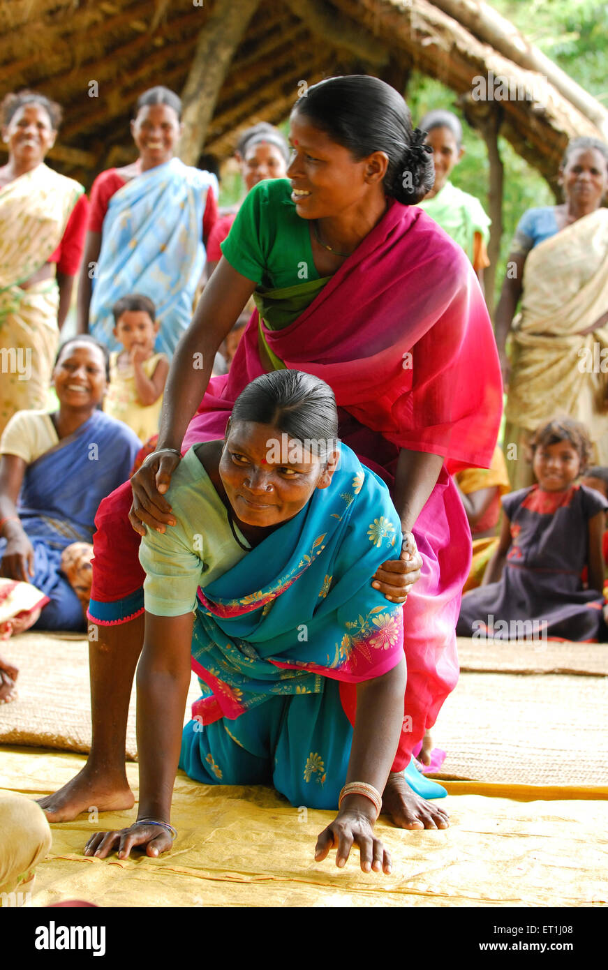 Ho tribes women playing piggybacking and sharing medical information ...