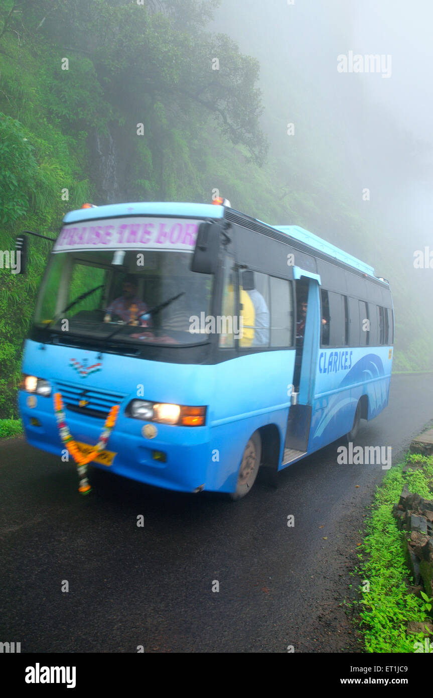 Tourist bus speeding in monsoon ; Mahabaleshwar ; Maharashtra ; India ...