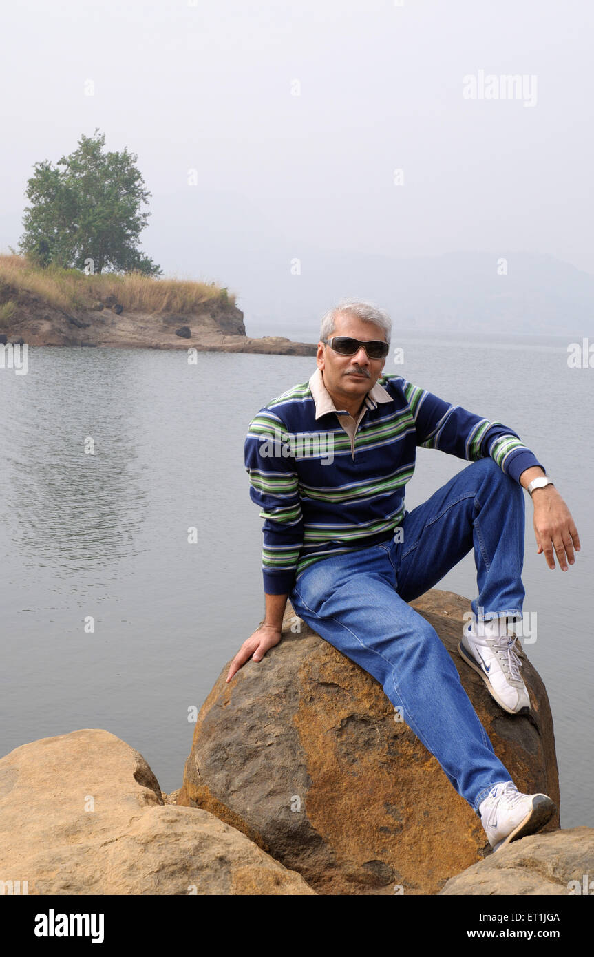 Indian man on rocks hi-res stock photography and images - Alamy