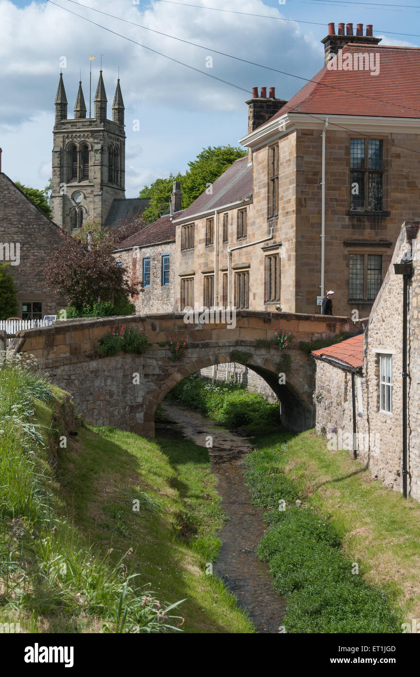 Helmsley market town and the All Saint's Church tower and stone bridge ...