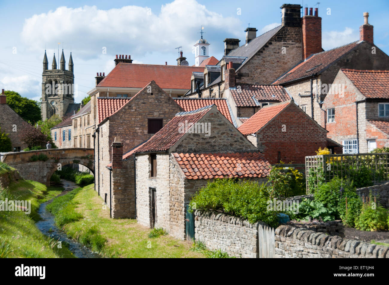 Helmsley market town and the All Saint's Church tower and stone bridge ...