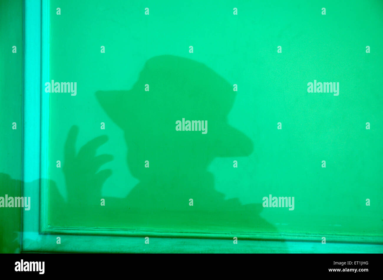 man wearing hat shadow on window Stock Photo - Alamy