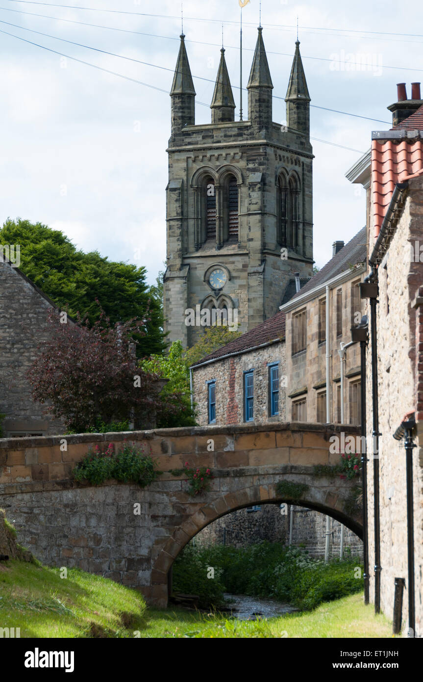 Helmsley market town and the All Saint's Church tower and stone bridge ...