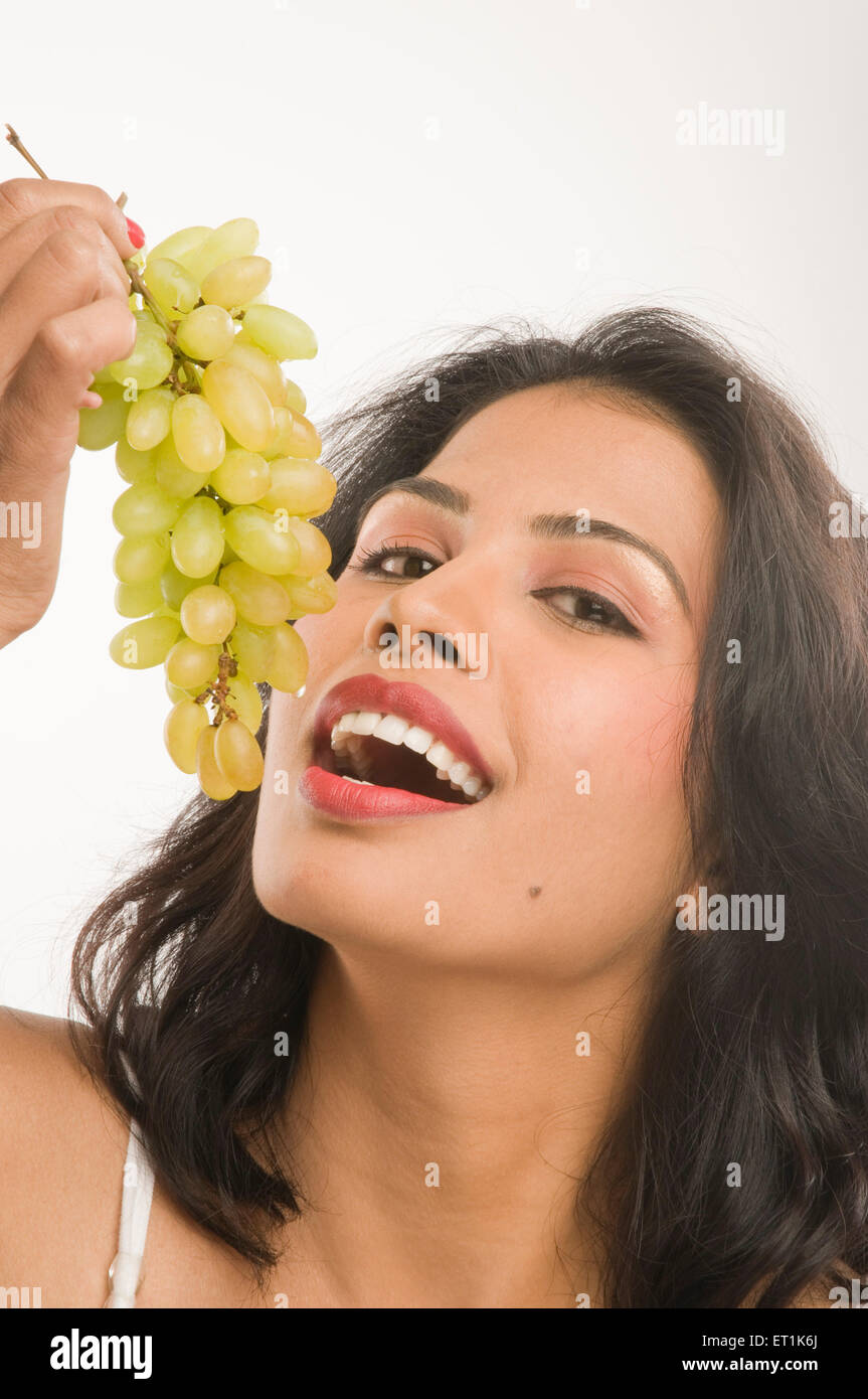 Lady eat grapes Pune Maharashtra India Asia Jan 2011 MR#686 W Stock ...
