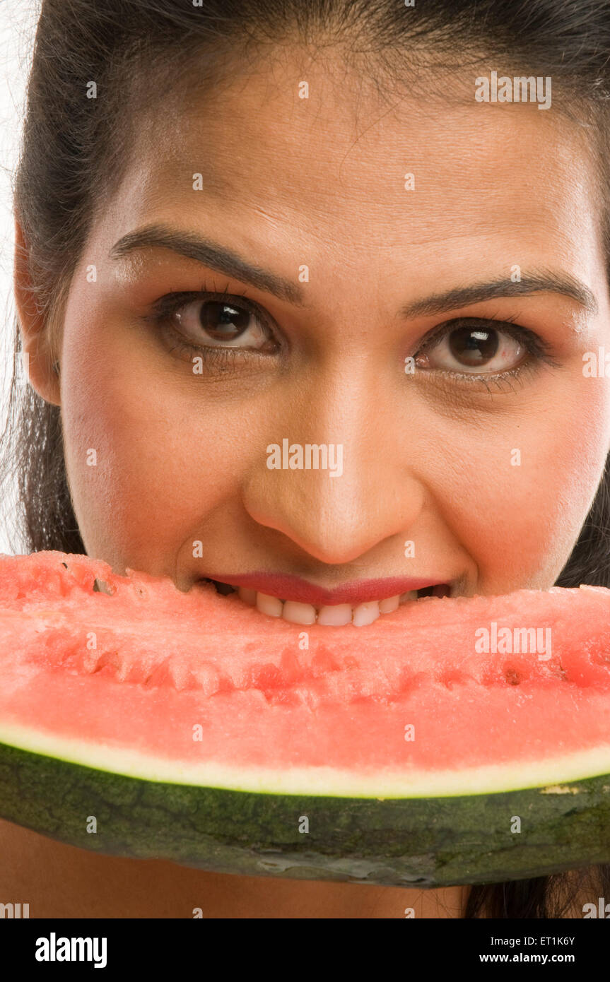 Lady biting Watermelon Pune Maharashtra India Asia Jan 2011 MR#686 W ...