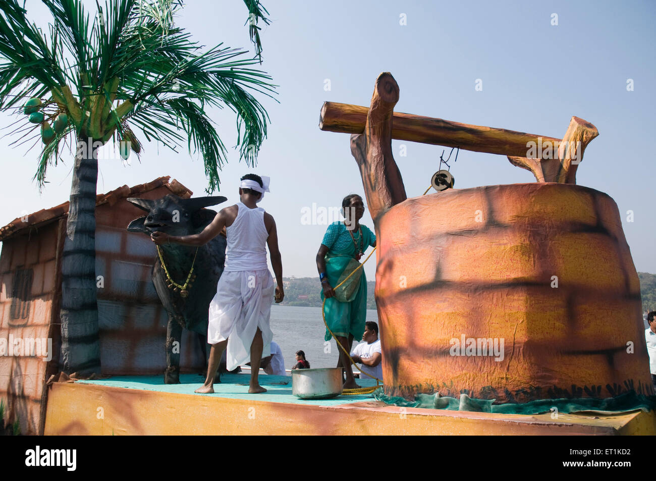 Couple with artificial well and buffalo Goa Maharashtra India Asia ...
