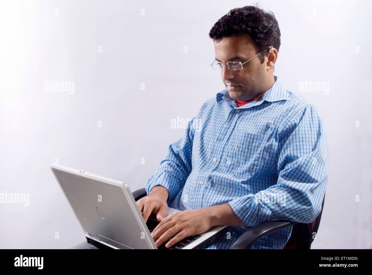 Young man using his laptop ; India MR#556 Stock Photo - Alamy
