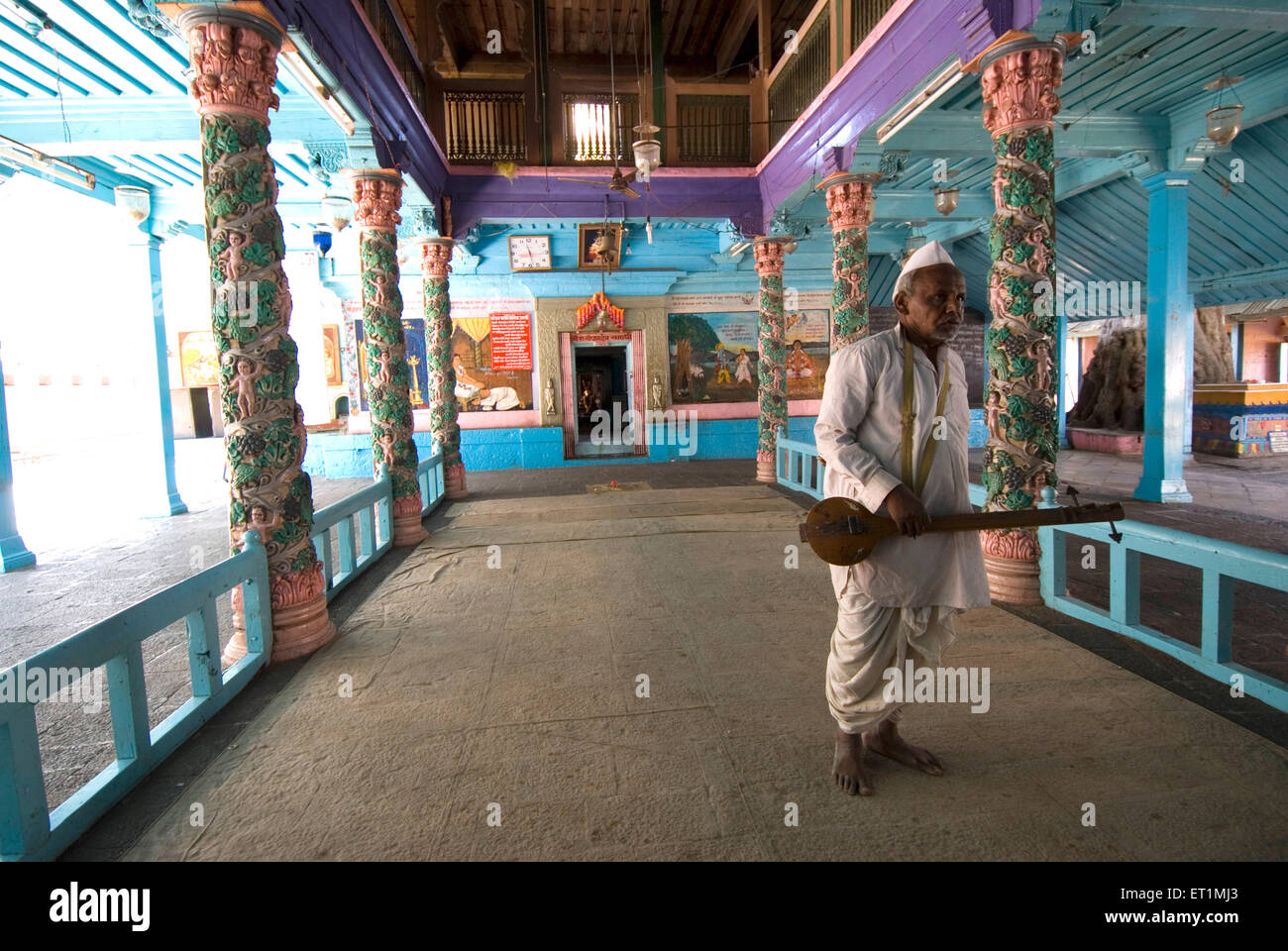 A devotee playing tambora a stringed instrument at Sopandev tomb temple ...