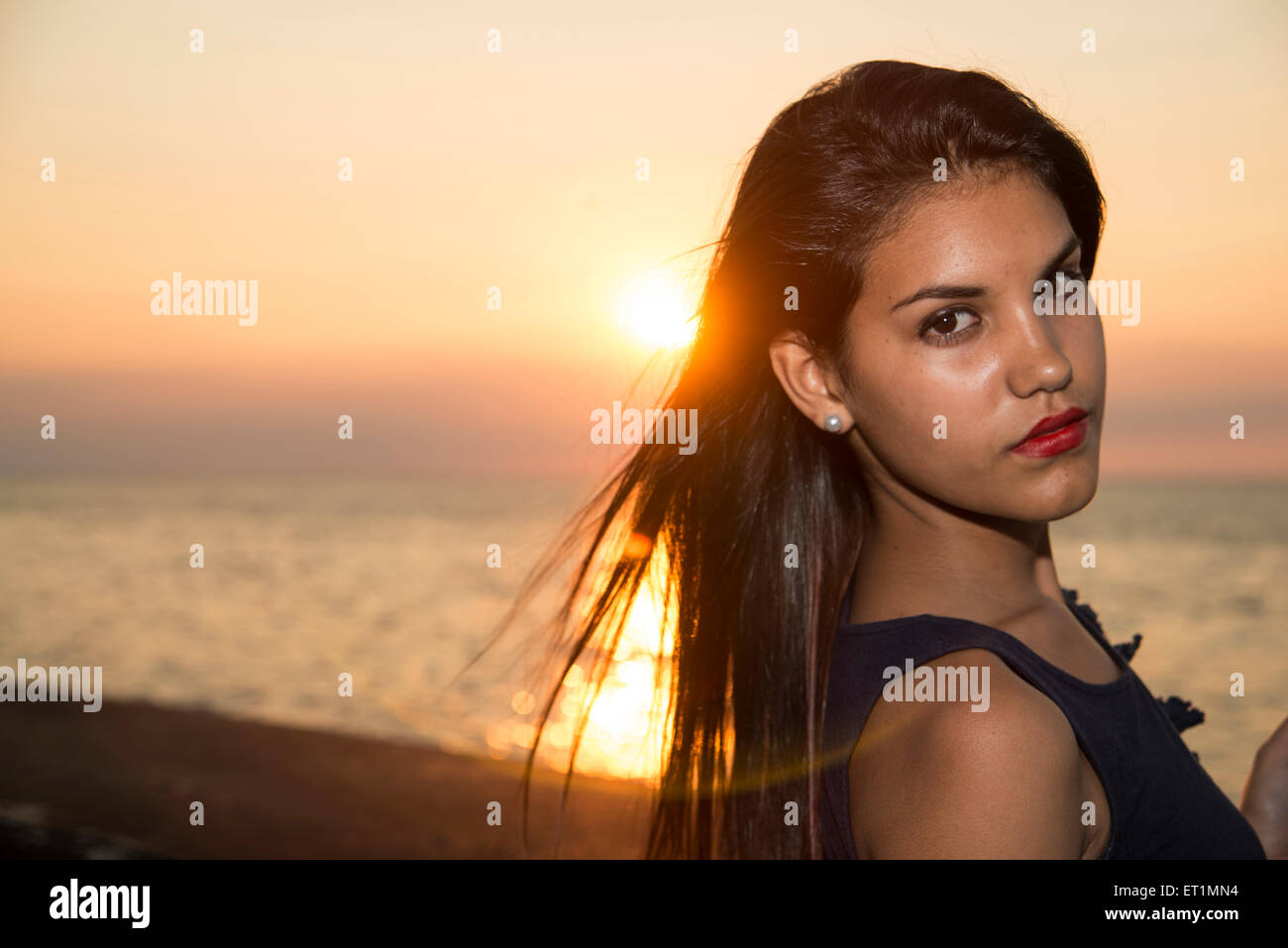 A Latin woman during sunset Stock Photo - Alamy