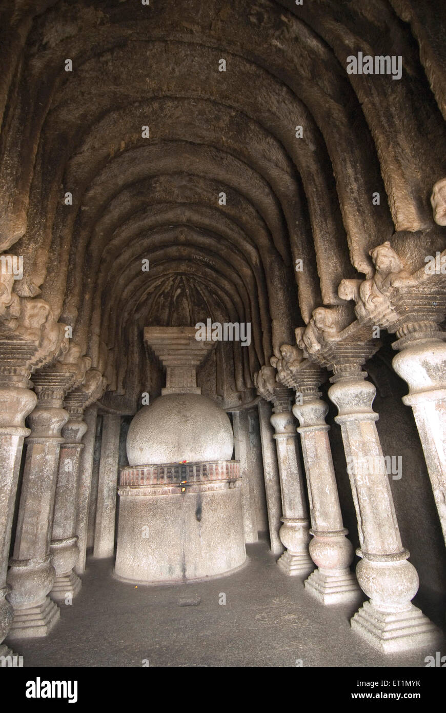 Richly carved stone stupa and pillars in Buddhist caves on mountain at ...