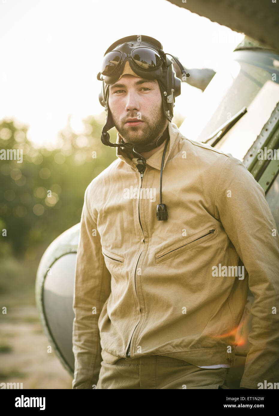 Young serious pilot posing near the helicopter Stock Photo - Alamy