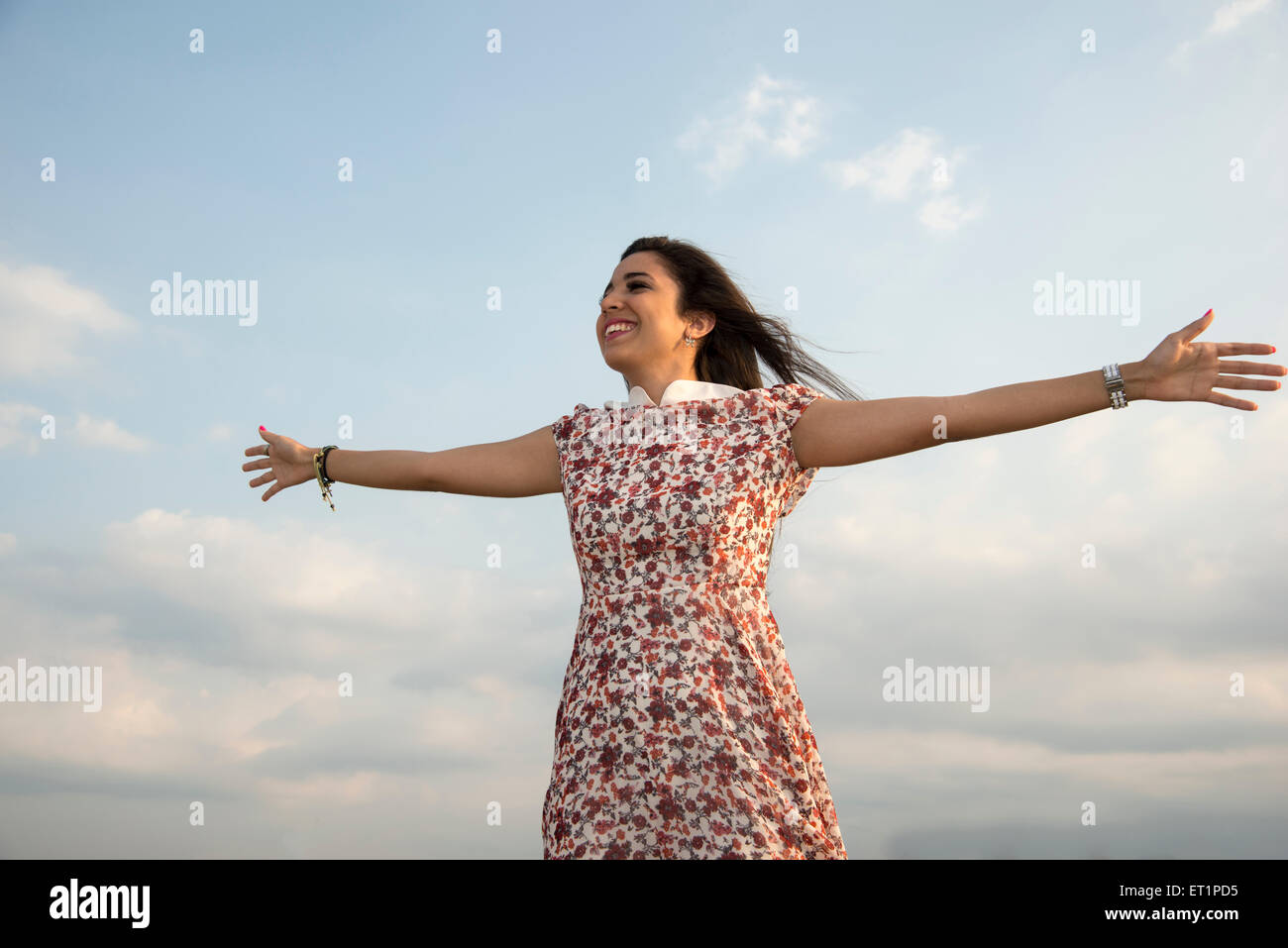 Woman with arms outstretched in nature Stock Photo - Alamy
