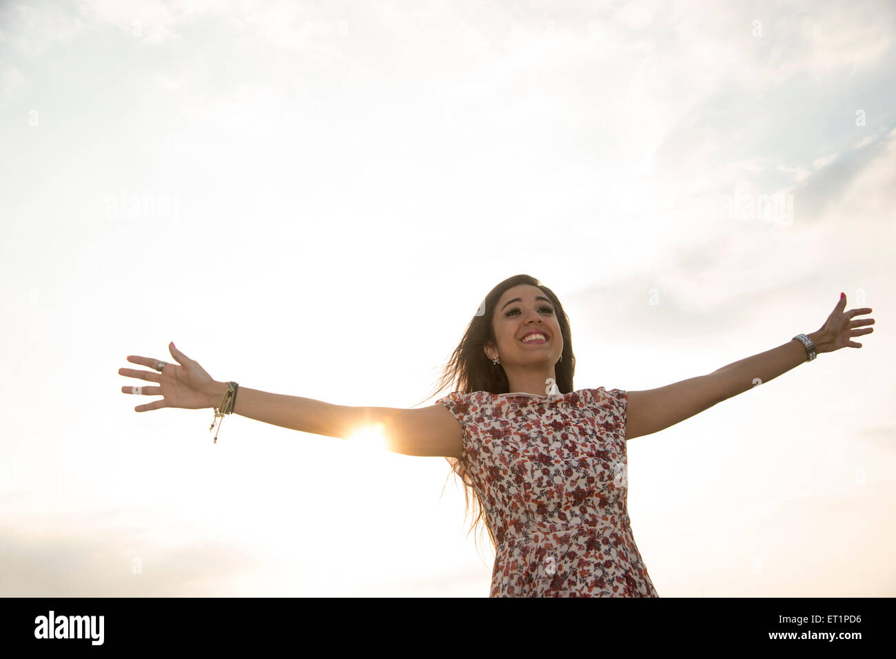 Woman with arms outstretched in nature Stock Photo - Alamy