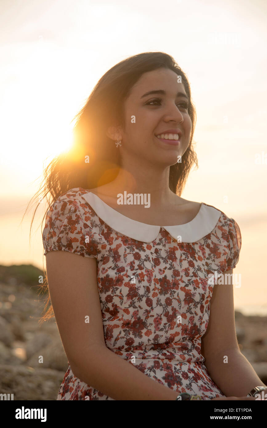 Young Latin woman enjoying the sunset Stock Photo - Alamy