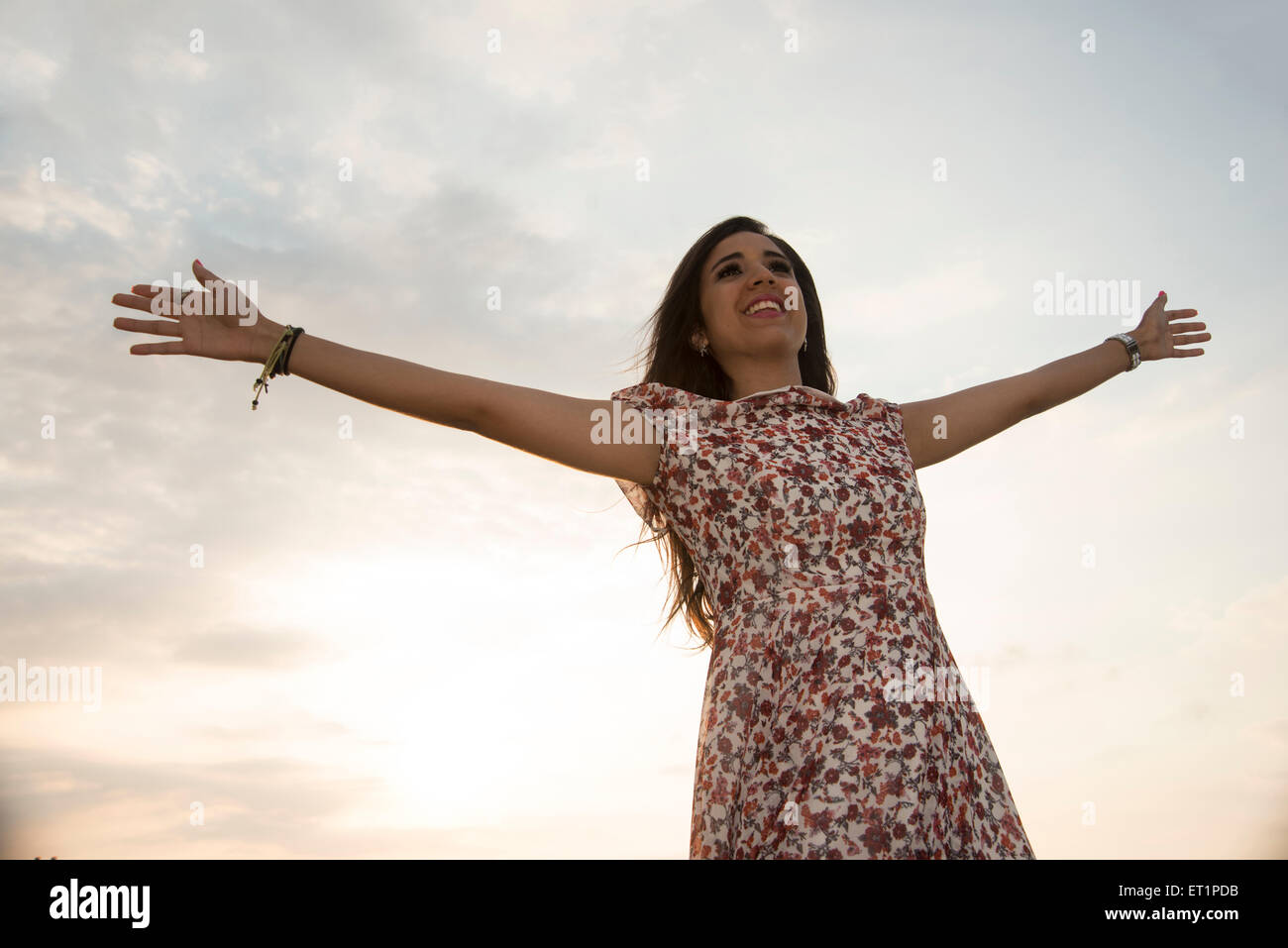 Woman with arms outstretched in nature Stock Photo - Alamy