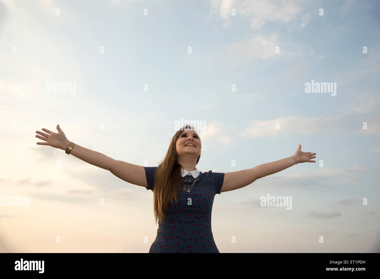 Woman with arms outstretched in nature Stock Photo - Alamy