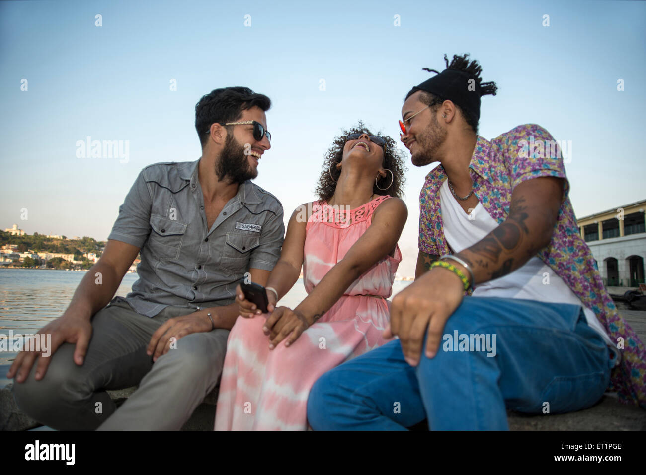Three friends having fun at Havana Port Stock Photo - Alamy