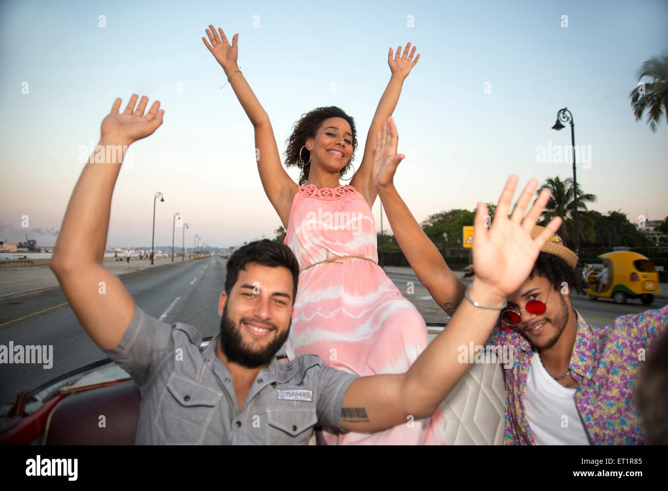 Three young people in a classic car Stock Photo - Alamy