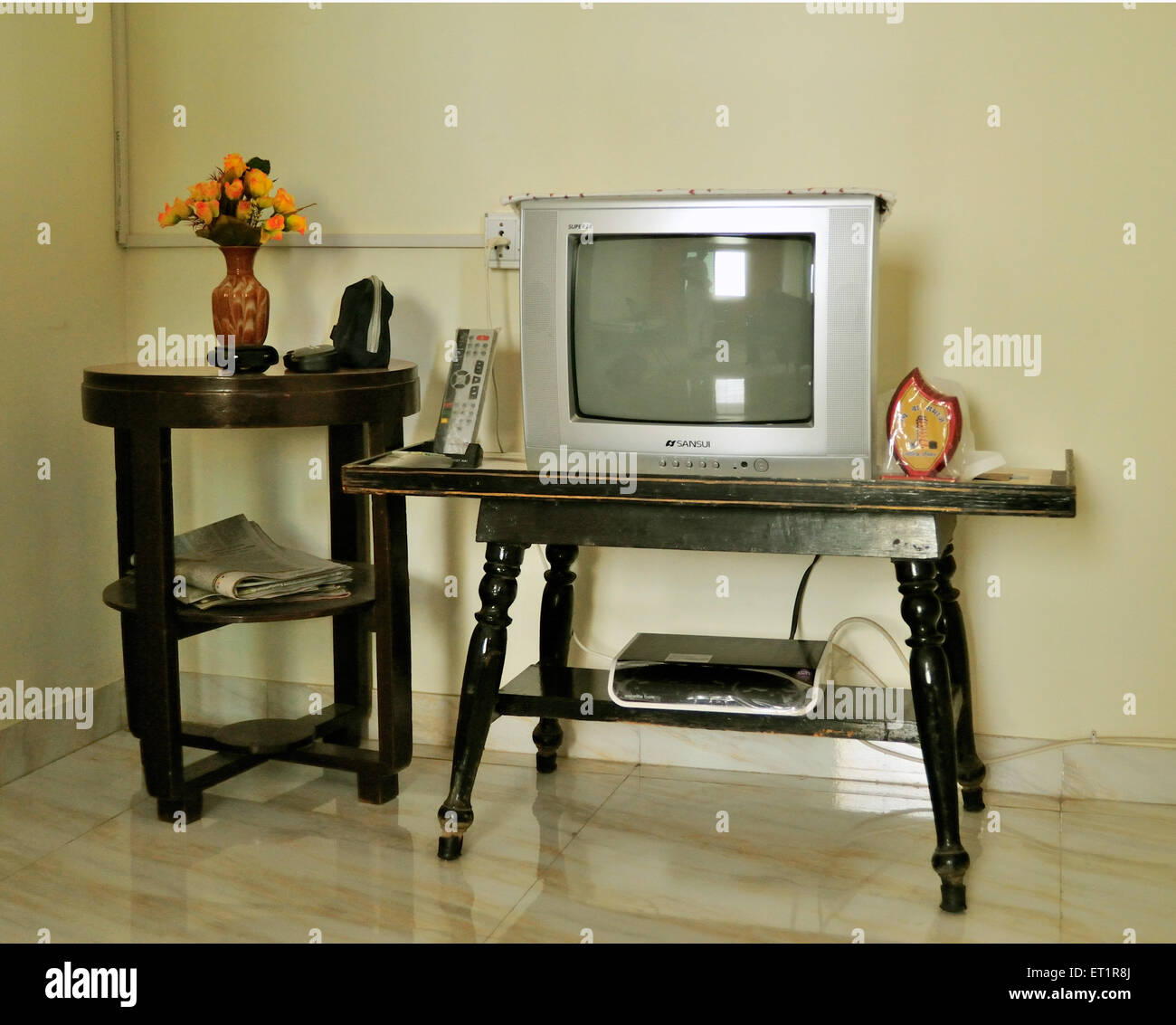 TV on wooden table and round table Stock Photo - Alamy