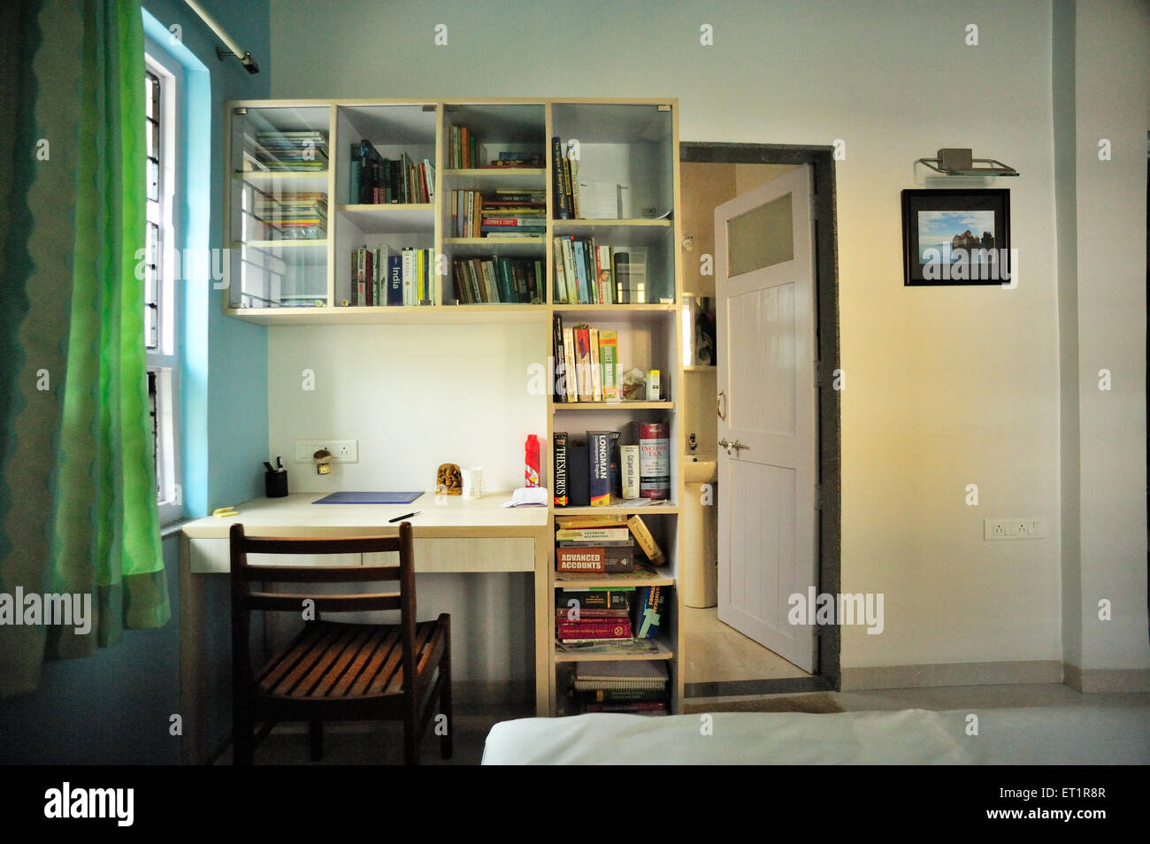 Study room writing table in house with bookshelf Stock Photo - Alamy