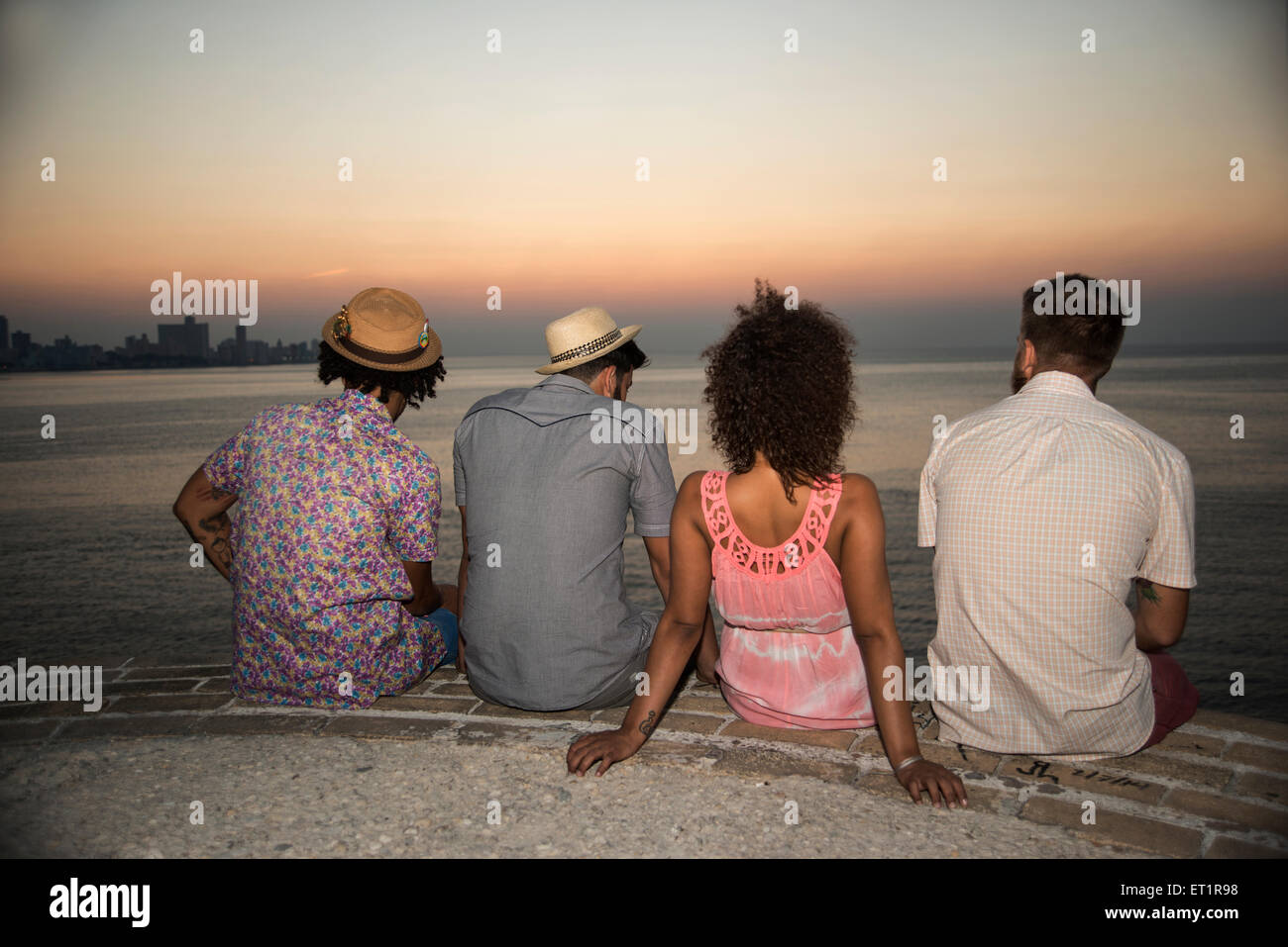 Group friends watching sunset over hi-res stock photography and images ...