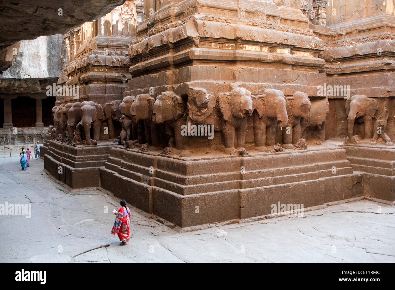 Huge elephants carved around the temples wall at kailasa rock cut ...