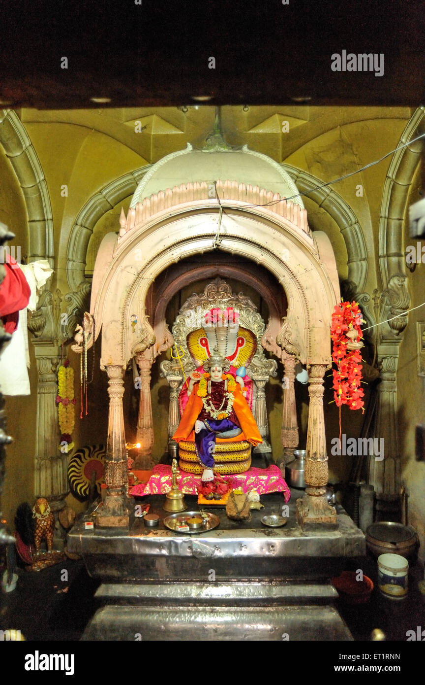 Idol of Lord Vishnu resting on sheshnag in hindu temple altar at ...