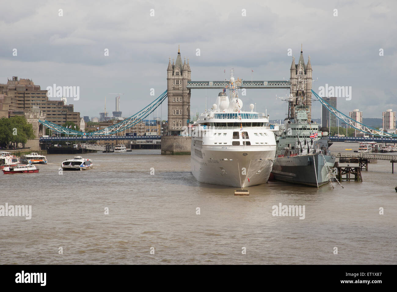 Cruise ship berthed next to HMS Belfast on the River Thames London UK ...