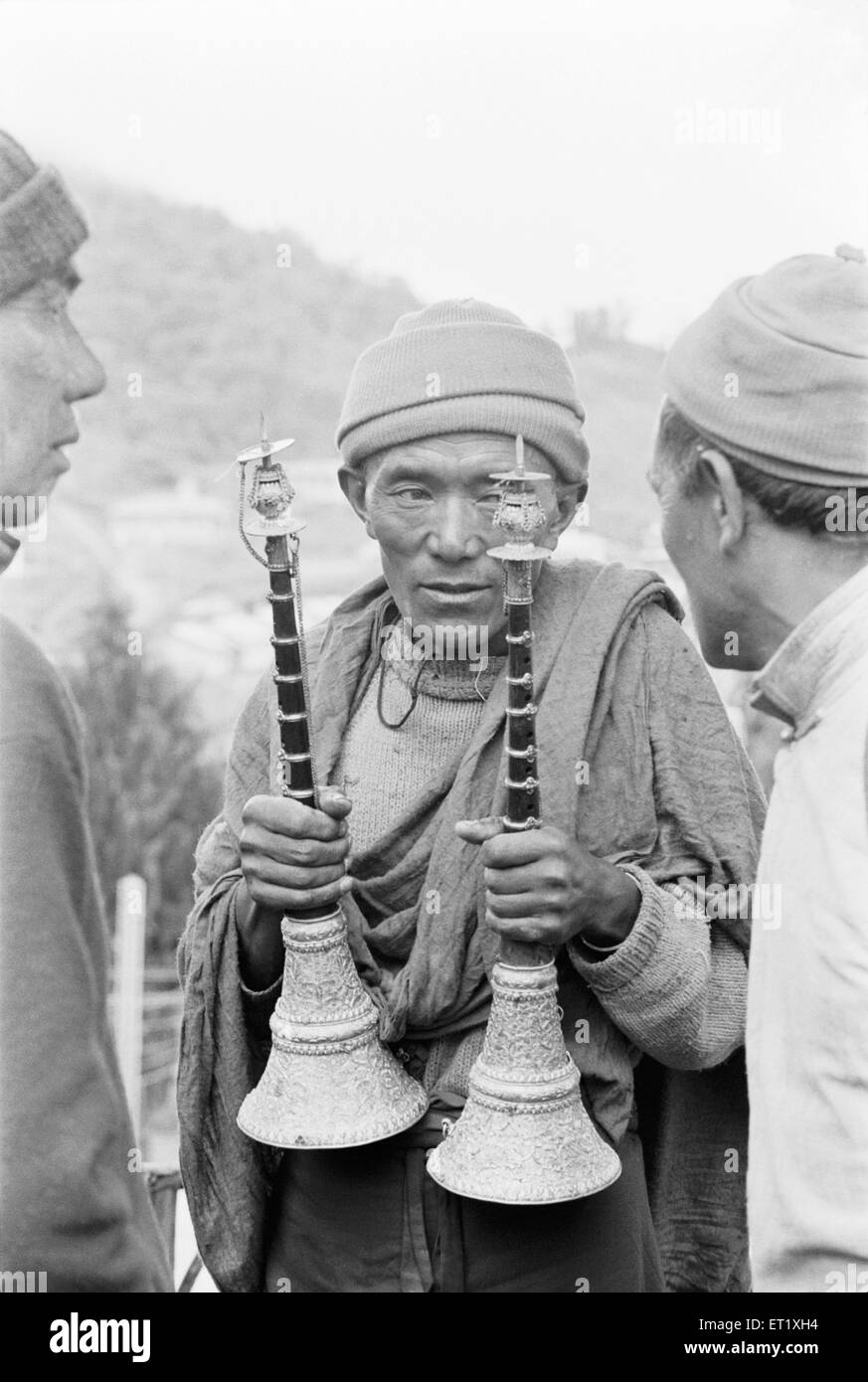 Man holding metal musical instrument ; Arunachal Pradesh ; India ; Asia ...