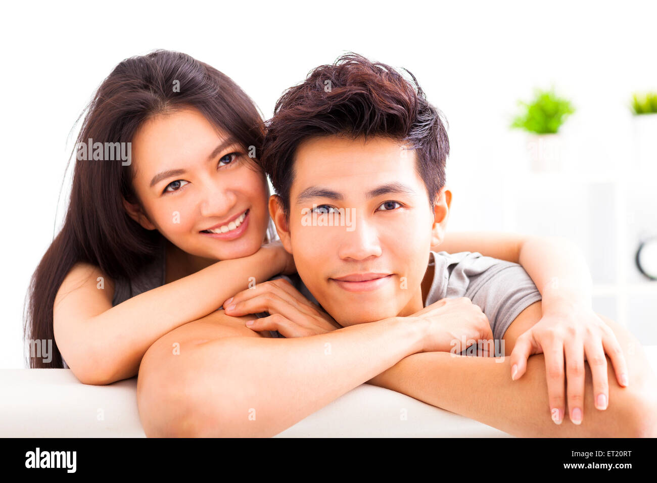 Young happy couple hugging and smiling Stock Photo - Alamy