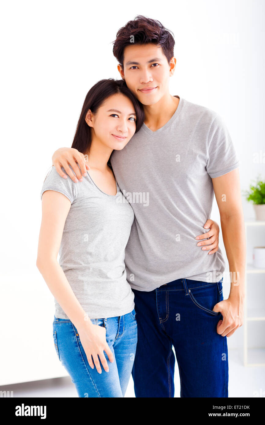 Young happy couple hugging and smiling Stock Photo - Alamy