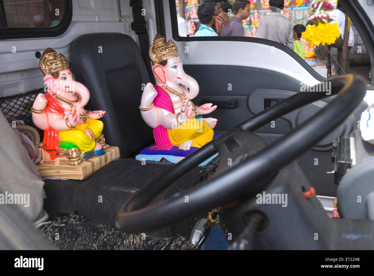 Idols of lord ganesha ganpati at steering wheel in car prior to ...