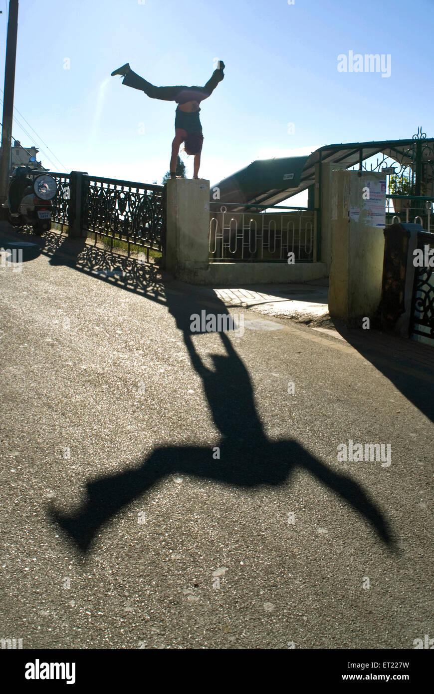 French acrobat doing handstand act to create play of shadows ...