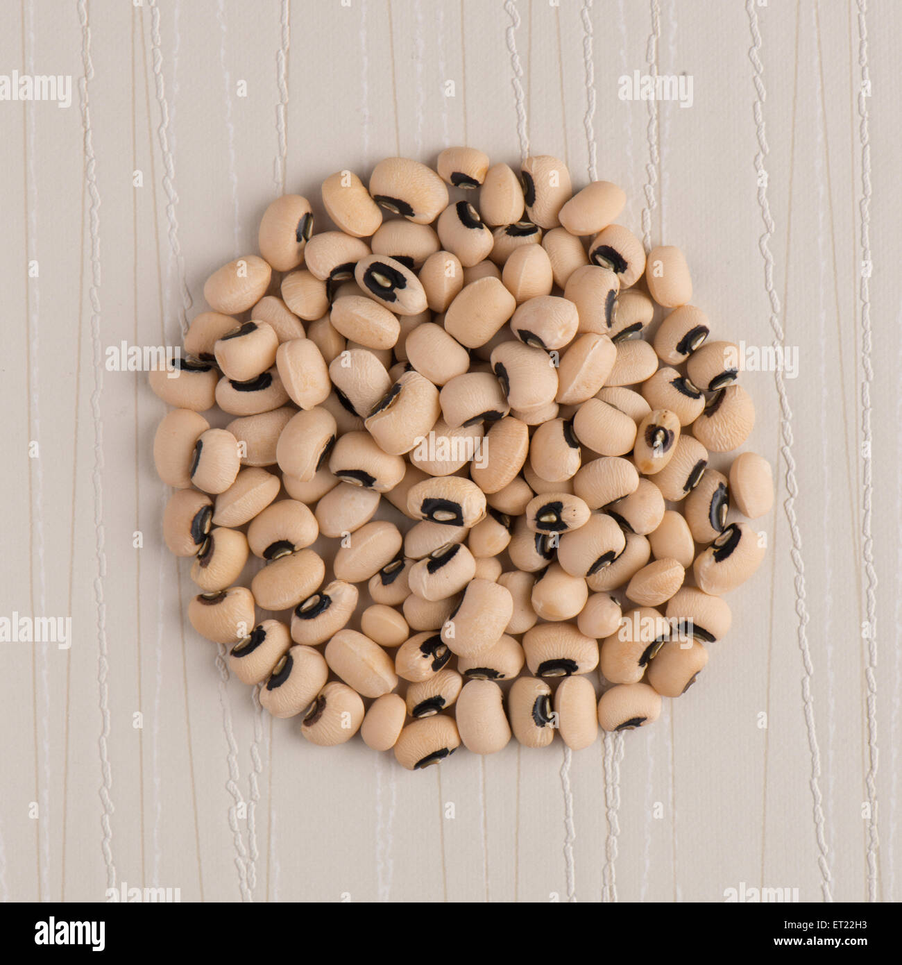 Top view of circle of white beans against beige vinyl background Stock ...