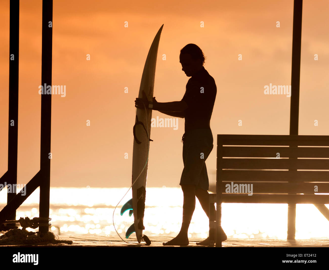 Surfer at sunset Stock Photo - Alamy
