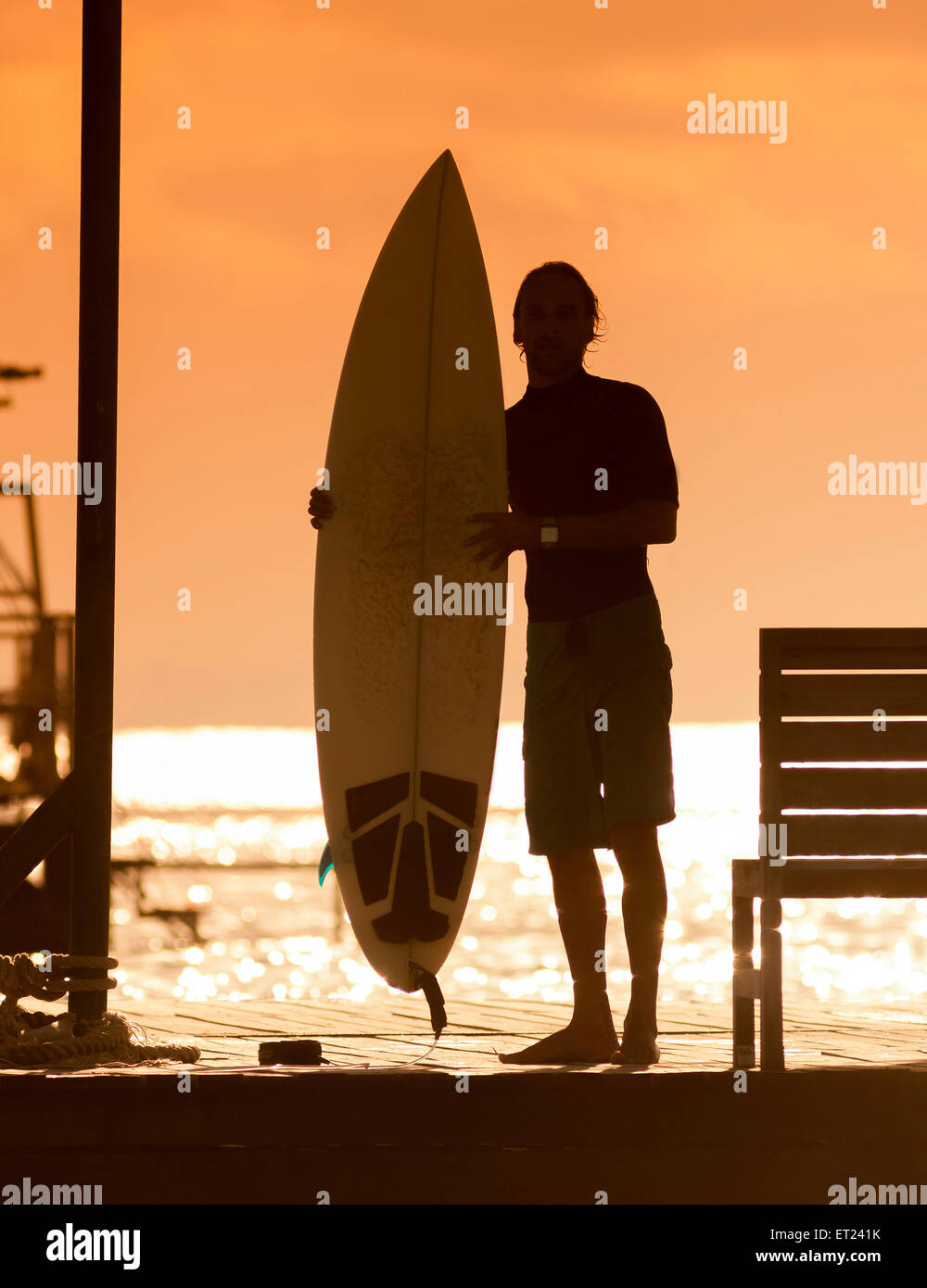 Surfer at sunset Stock Photo - Alamy