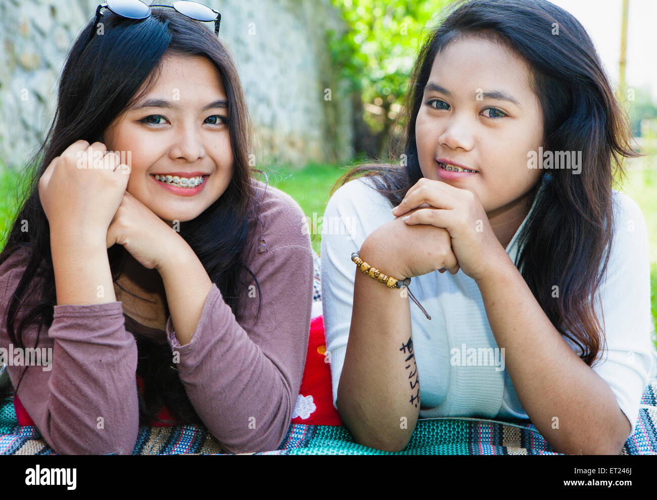 Two asian girl smiling and happy outdoor in the park Stock Photo - Alamy