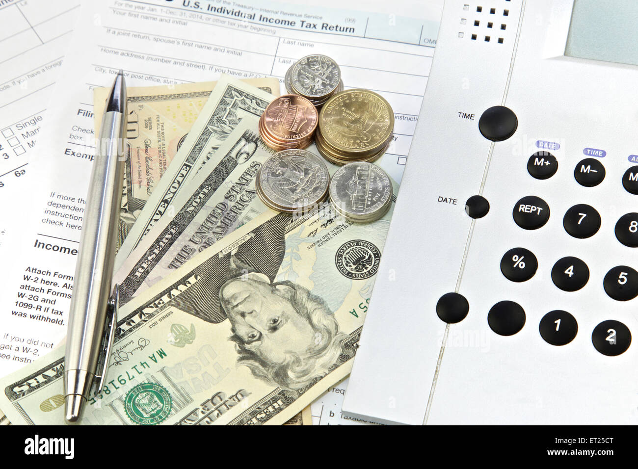 Dollar bills, calculator and 1040 tax return form. US Federal Income ...