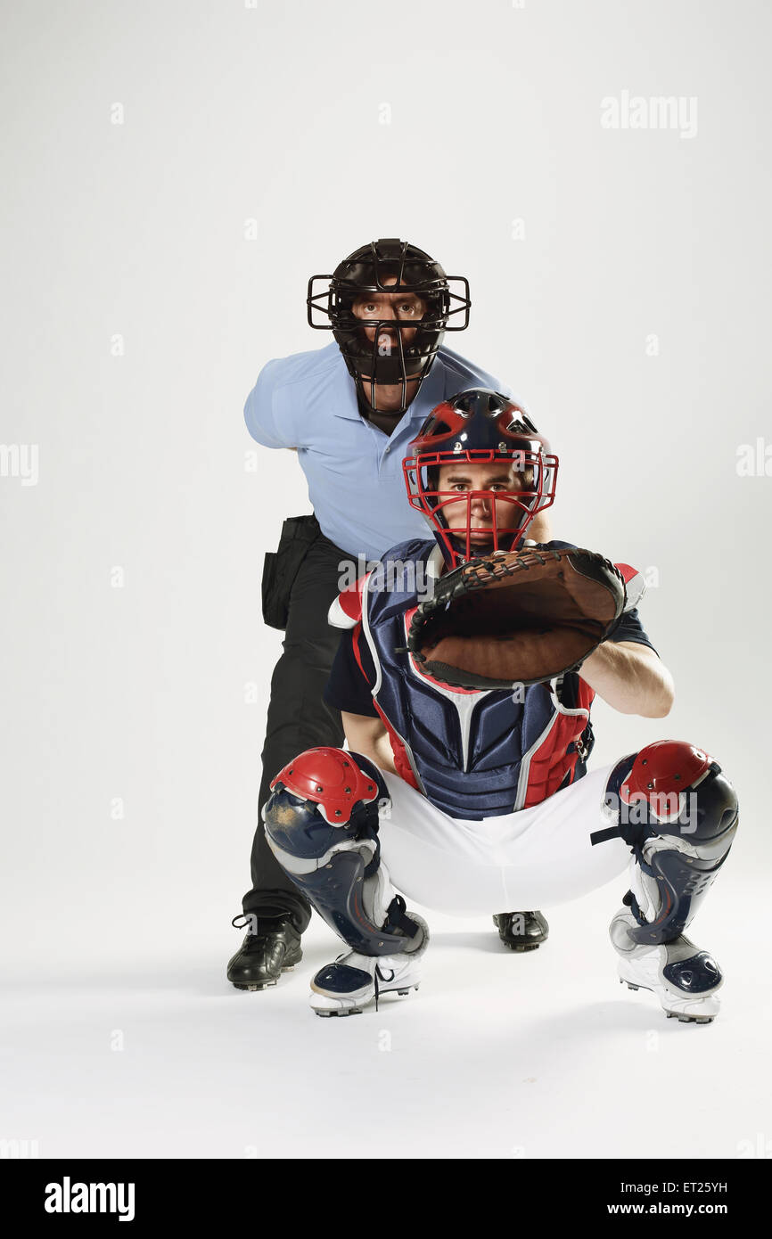 Baseball catcher and chief referee against white background Stock Photo ...