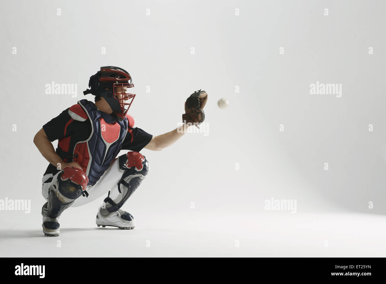 Baseball catcher against white background Stock Photo - Alamy