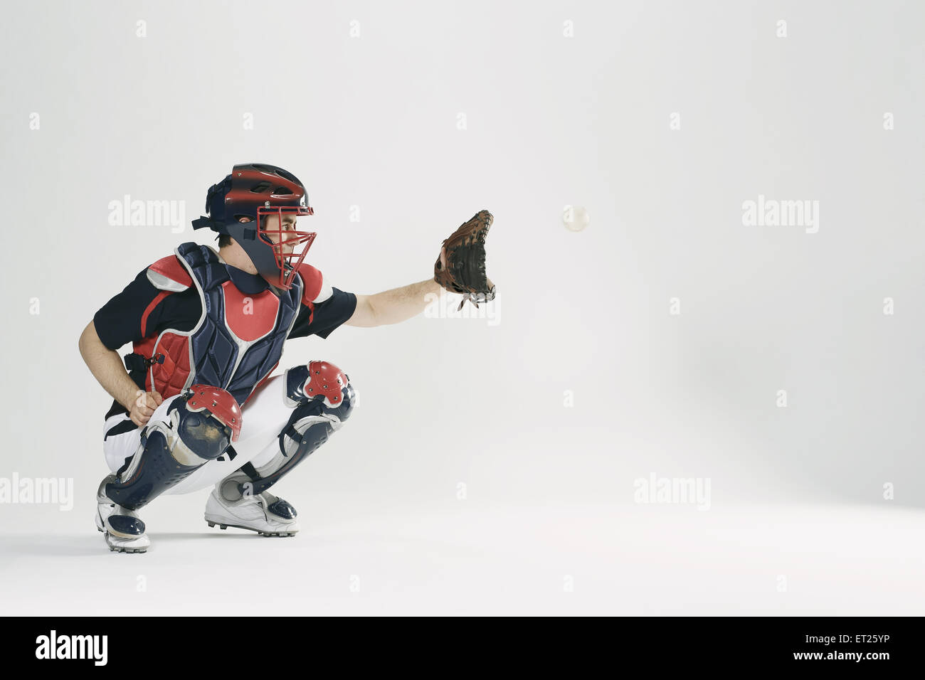 Baseball catcher against white background Stock Photo - Alamy