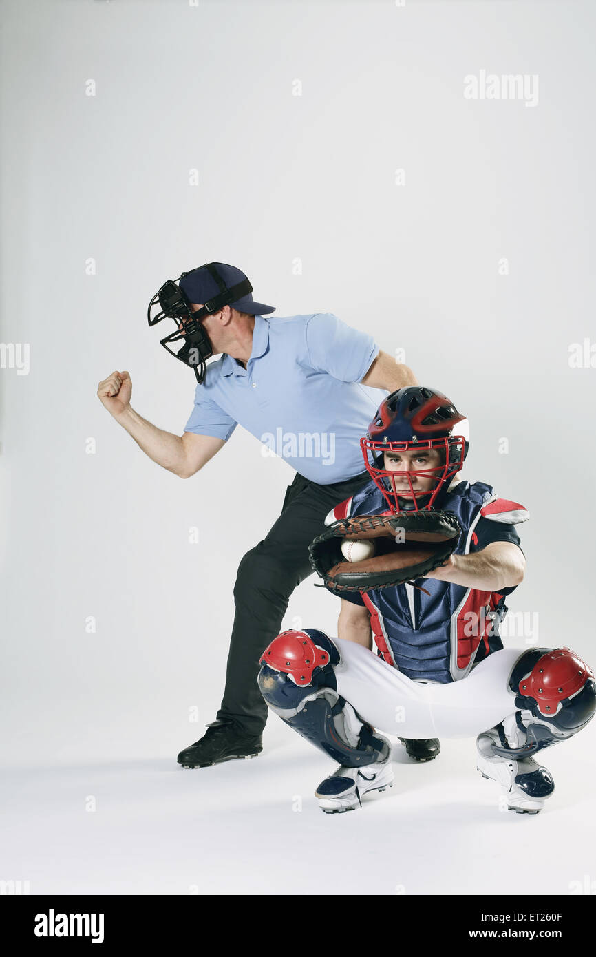 Baseball catcher and chief referee against white background Stock Photo ...