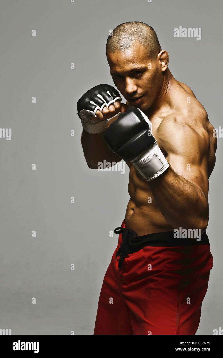 Bald male athlete in a fighting pose Stock Photo - Alamy