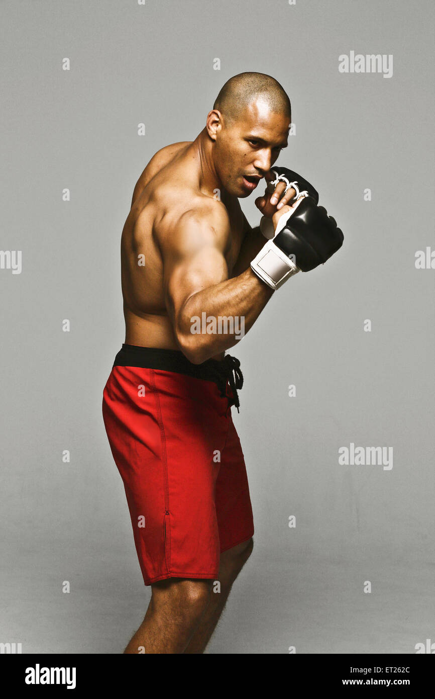 Bald male athlete in a fighting pose Stock Photo - Alamy