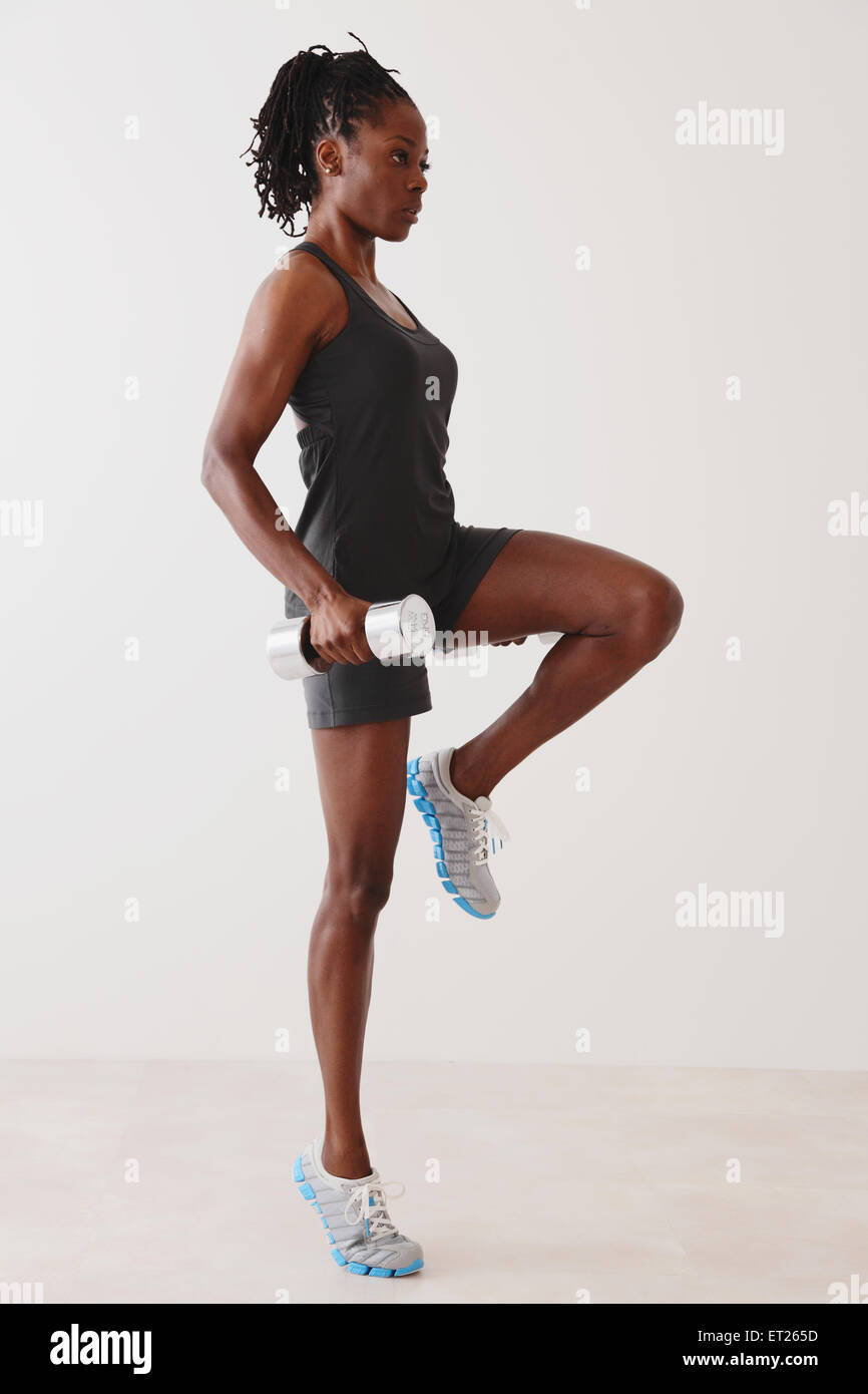 African Woman Exercising With Dumbbells Stock Photo - Alamy