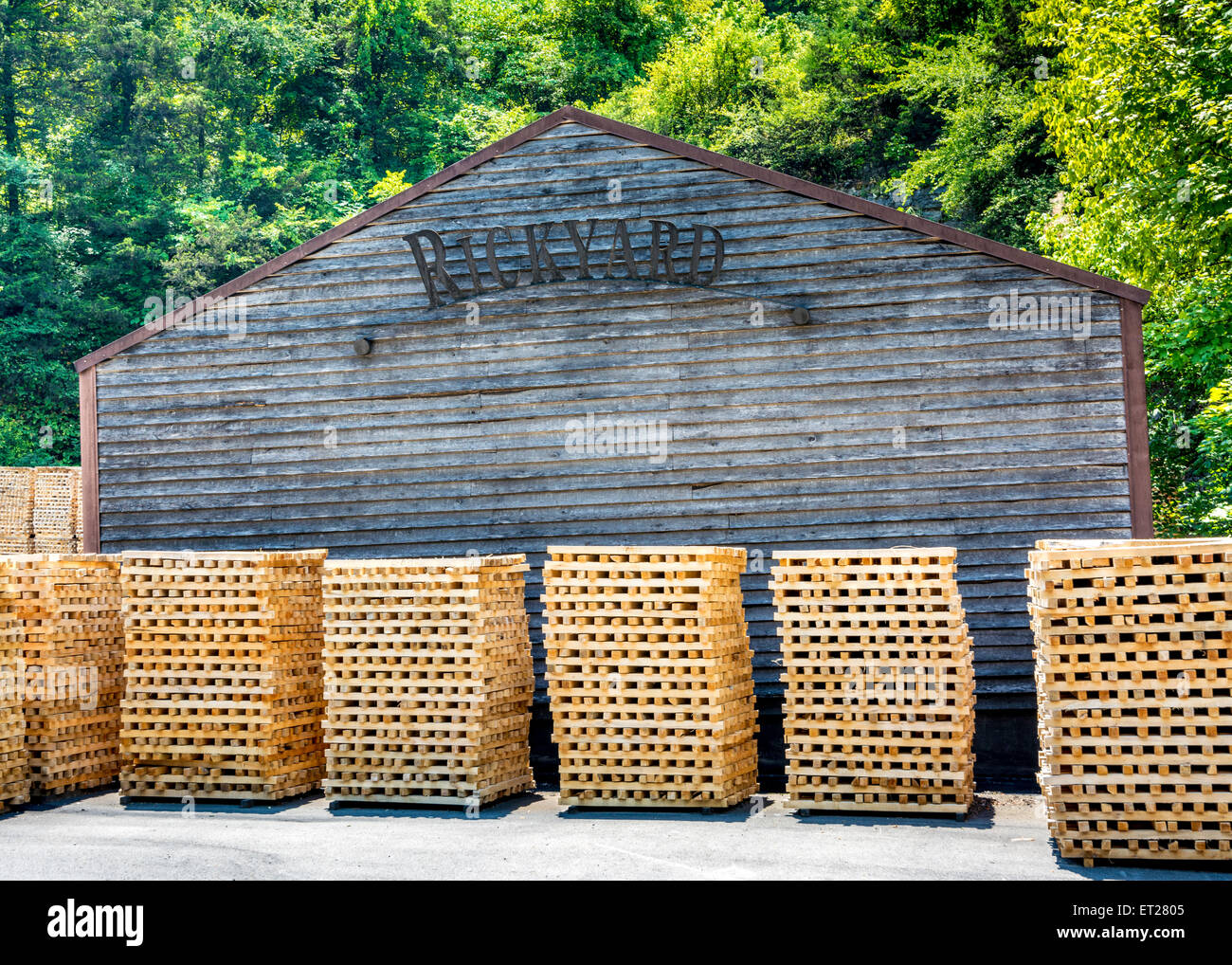 STacks of wood sticks and old weathered building Stock Photo - Alamy