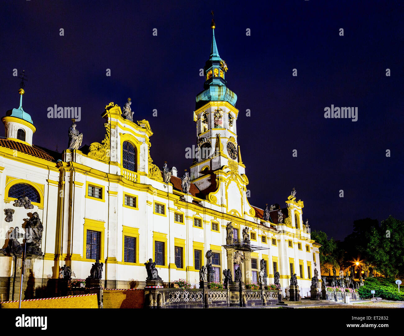 Night view of facade of Loreta church in Prague: green rooftop on white ...