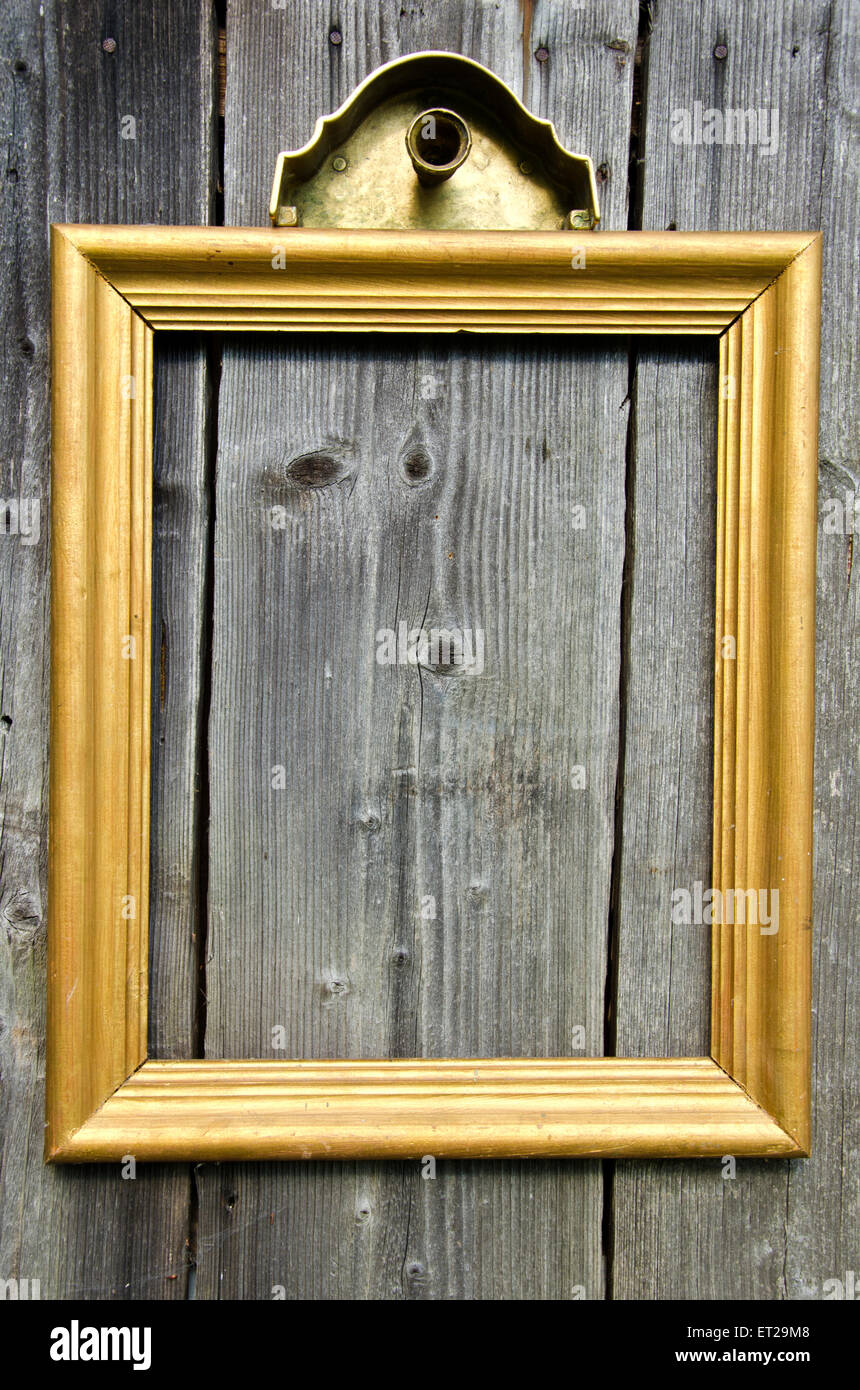 vintage empty golden wooden picture frame on old wooden wall background ...